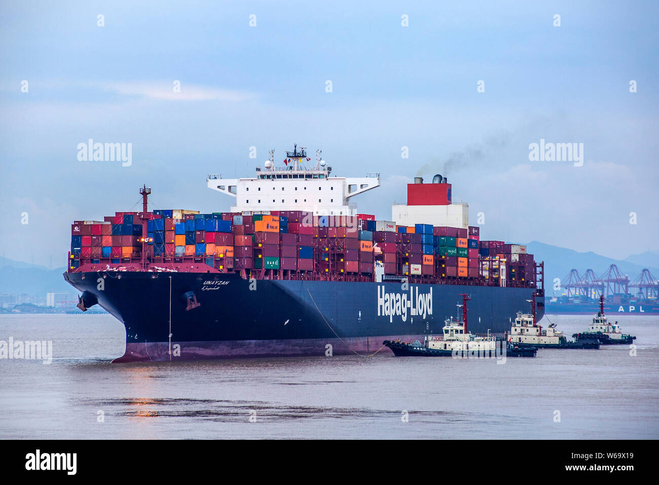A cargo ship loaded with 1,690 twenty-foot equivalent units (TEUs) is ...