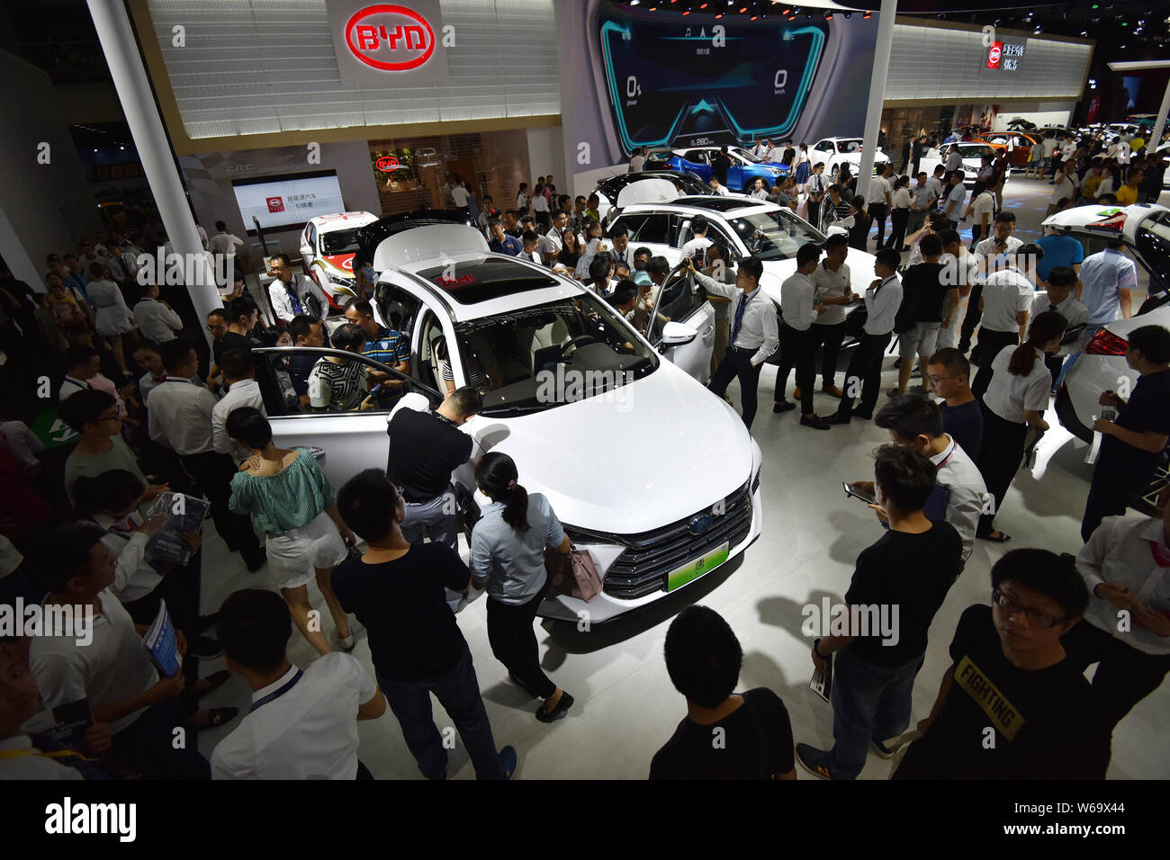 Visitors look at a Tang plug-in hybrid SUV of BYD during the 22nd ...