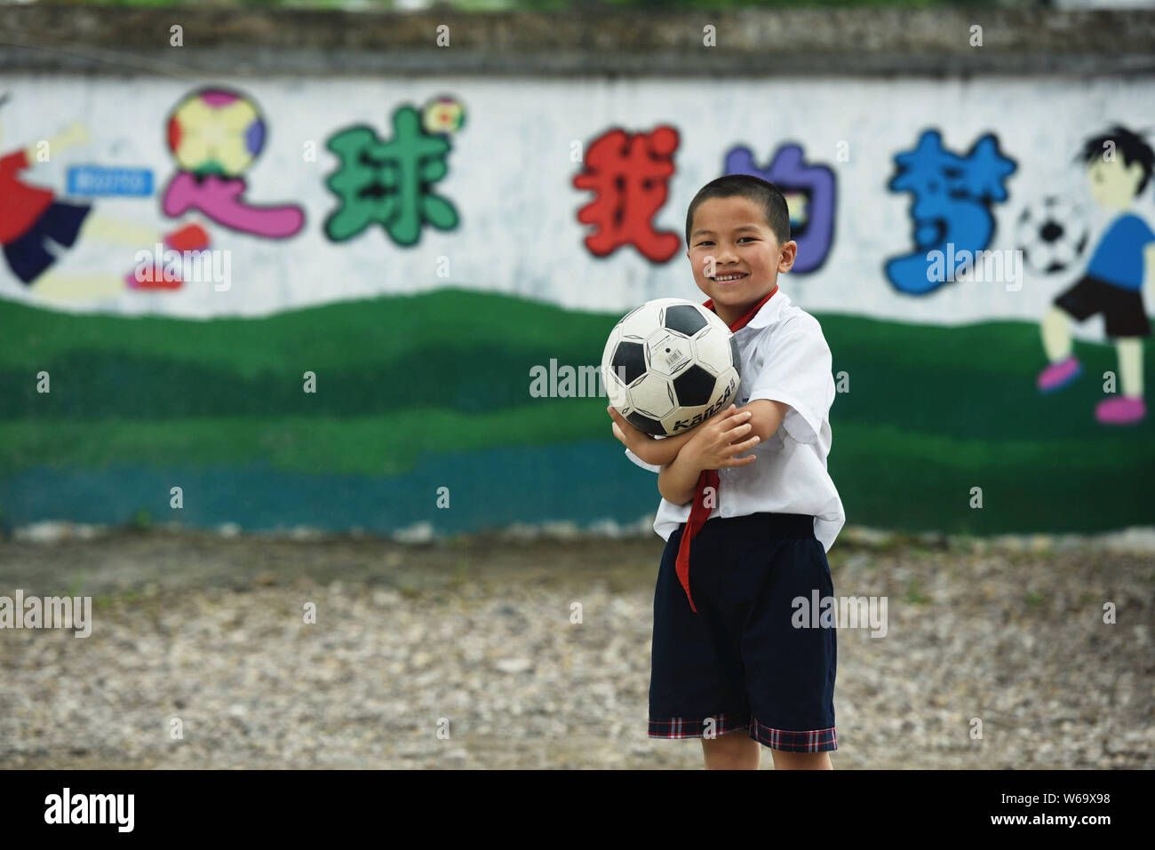 A young Chinese student plays football during the inauguration ceremony ...