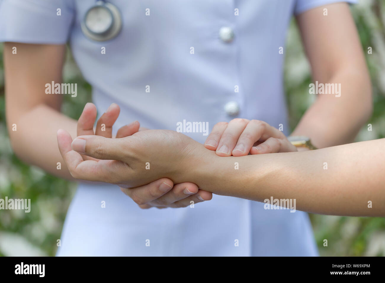 nurse is checking patience's pulse, medical checking Stock Photo - Alamy