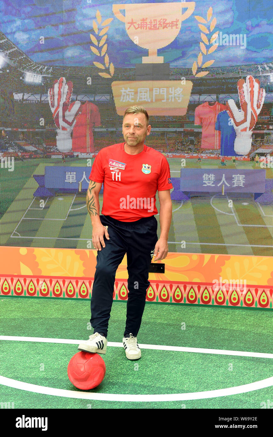 German former football player Thomas Hassler, in red, attends a ...