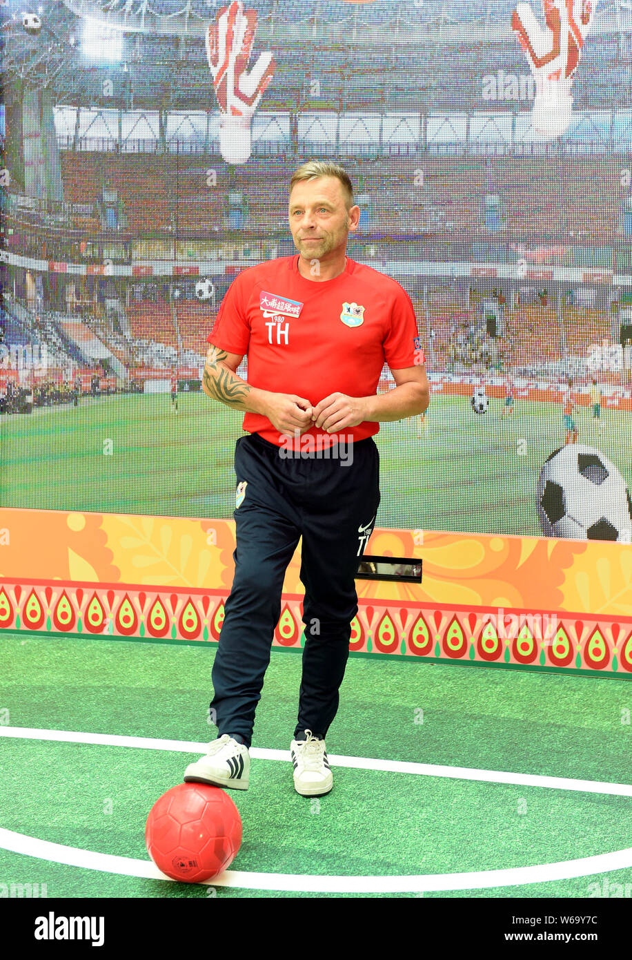 German former football player Thomas Hassler, in red, attends a ...