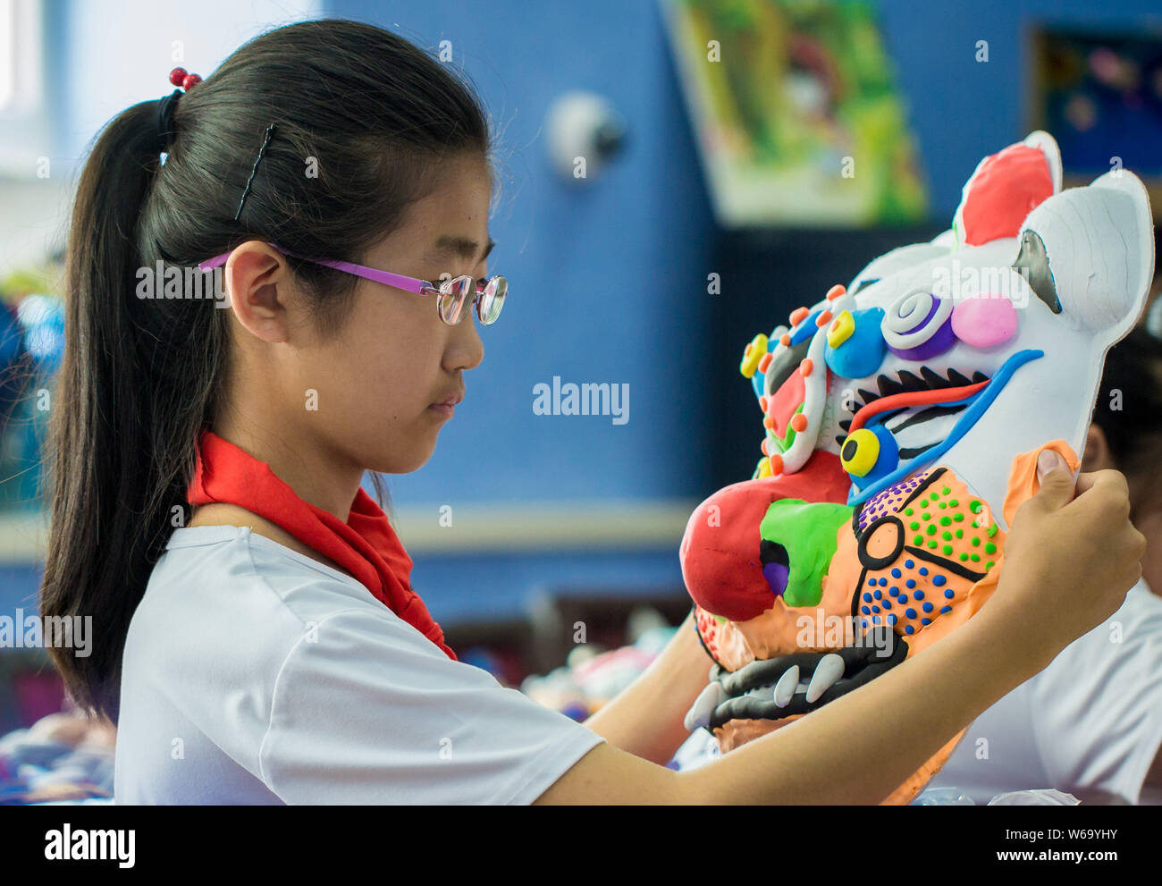 Primary school students make traditional auspicious beast masks under ...