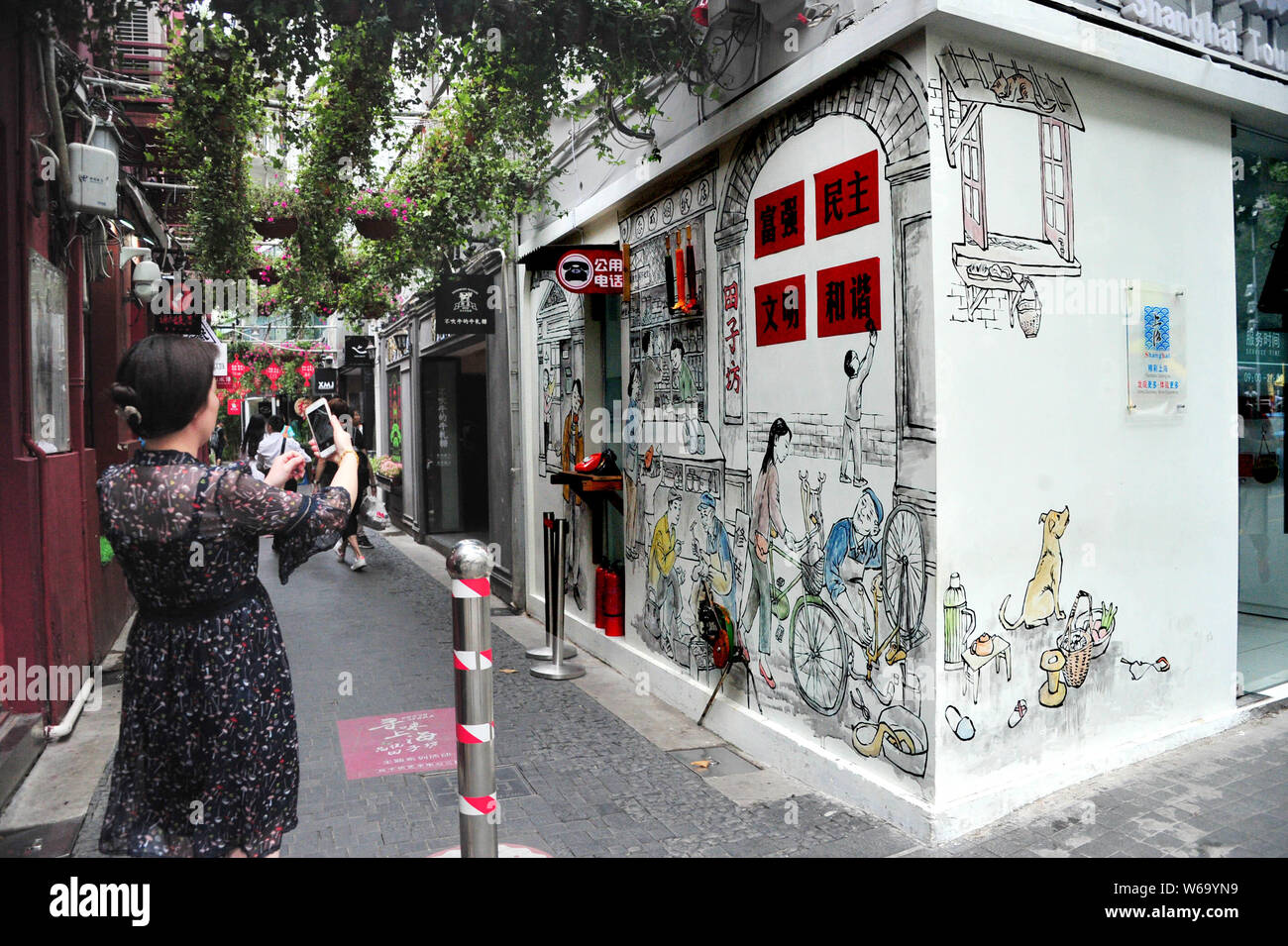 Tourists visit the Tianzifang or Tianzi Fang decorated with Shikumen, a ...