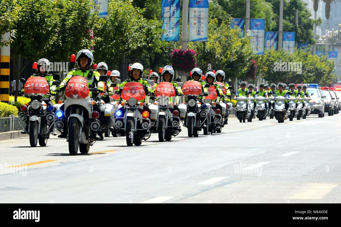 Chinese auxiliary traffic police officers ride motorcycles during a ...