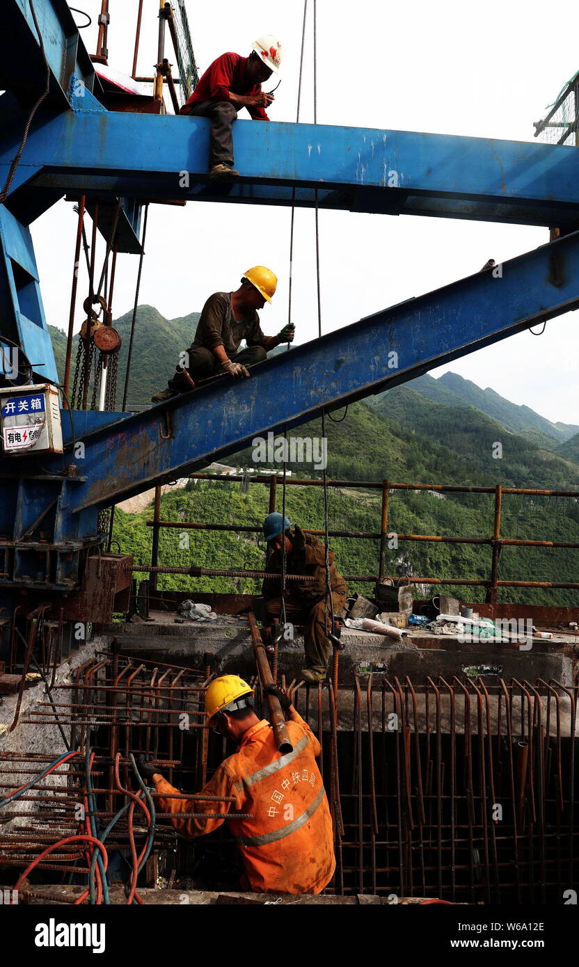 Chinese workers labor at the construction site of the stayed cable ...