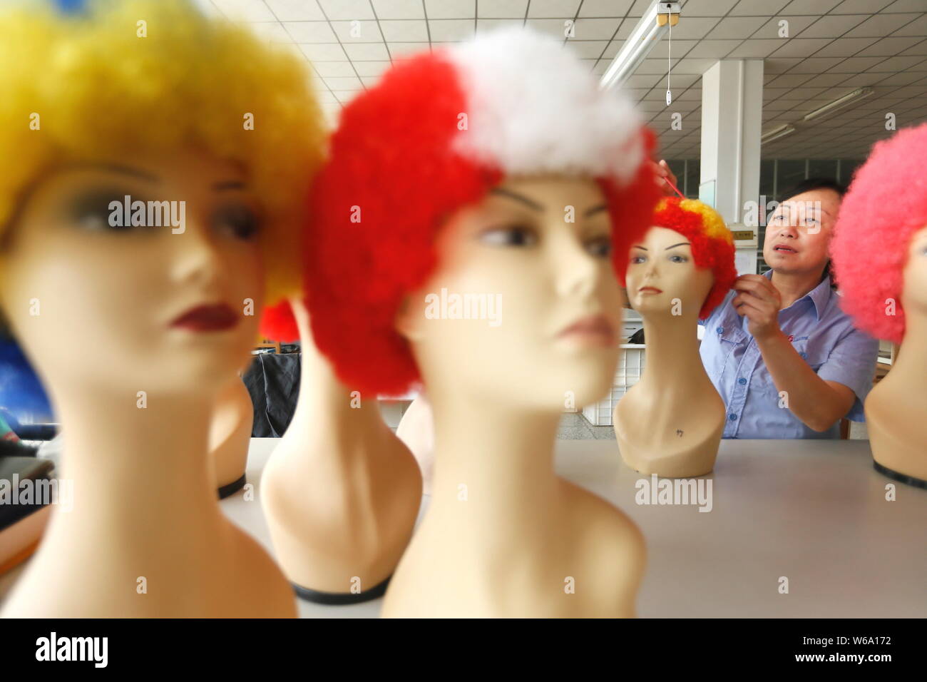 Tailor-made wigs for fans of the 2018 FIFA World Cup are on display at ...