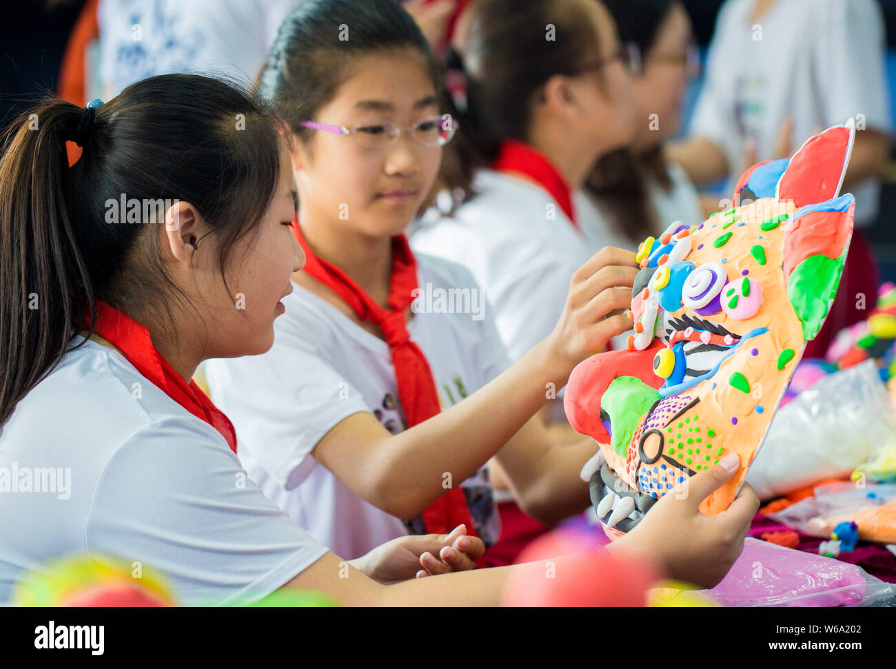 Primary school students make traditional auspicious beast masks under ...