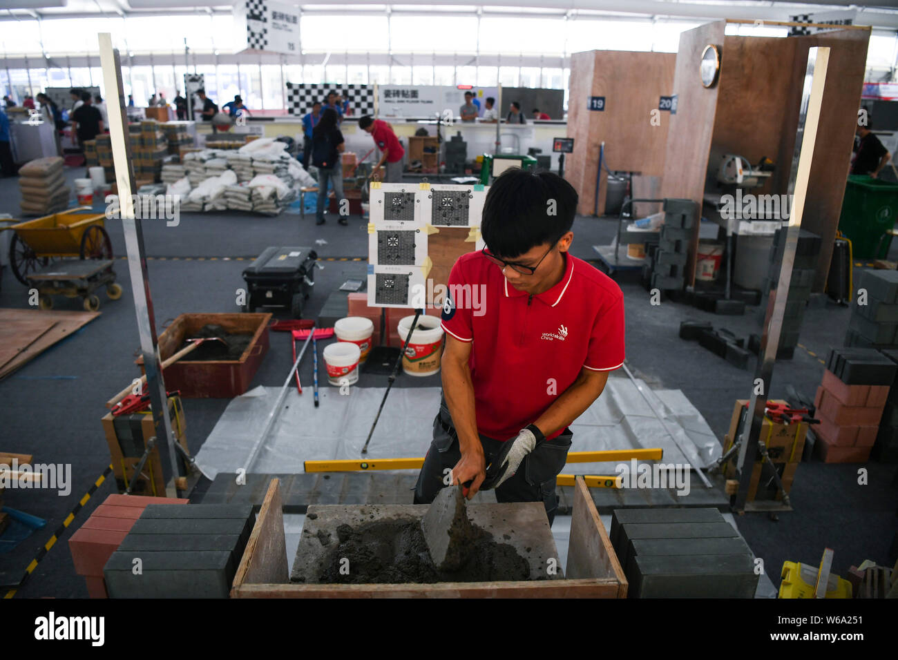 A participant shows bricklaying skill as he attends the WorldSkills ...