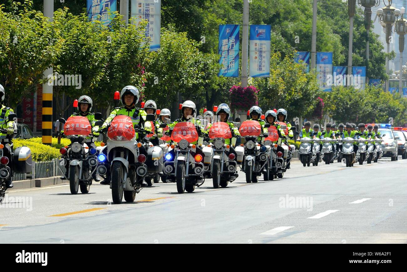 Chinese auxiliary traffic police officers ride motorcycles during a ...