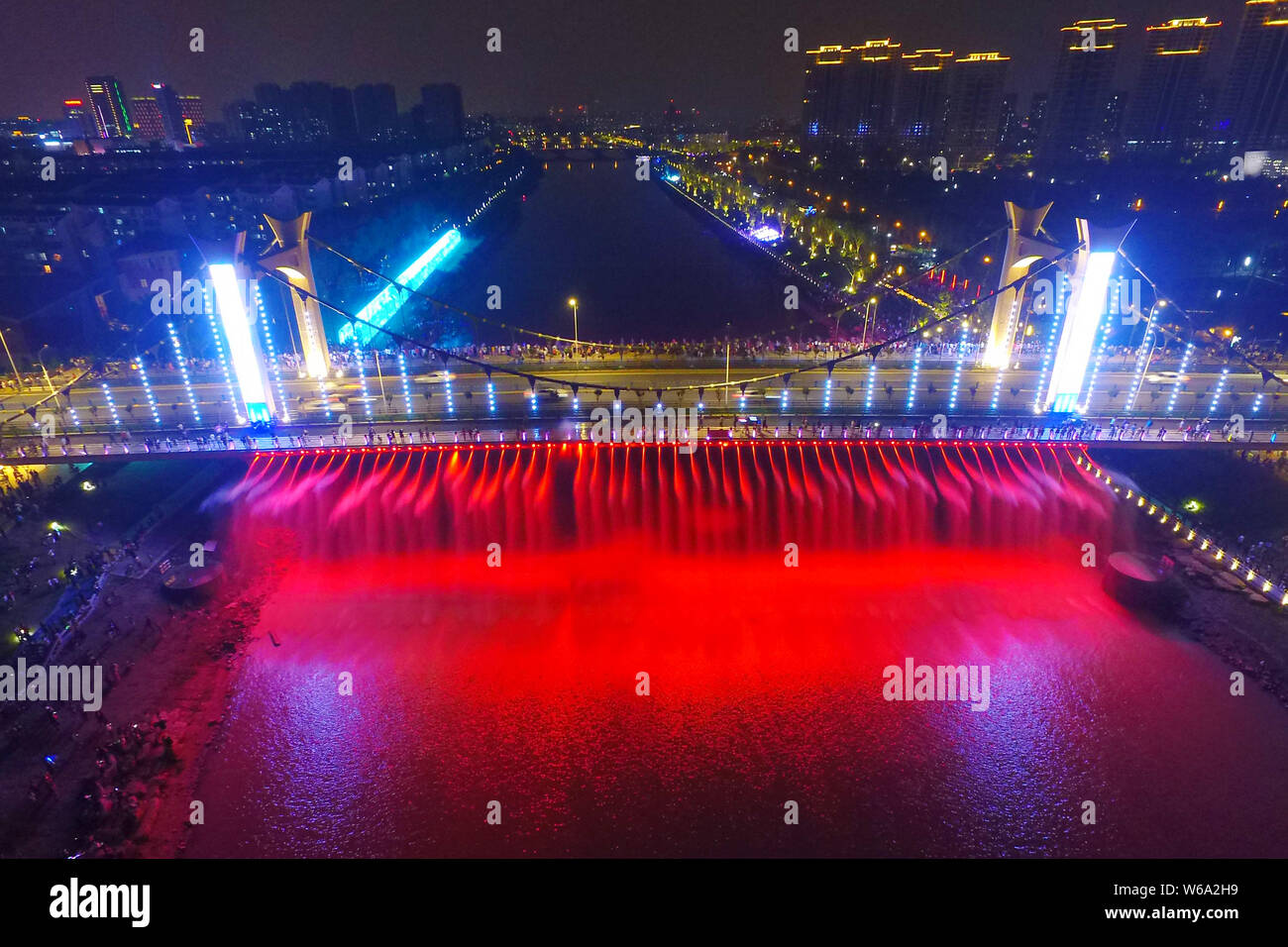 Aerial view of the Xiaolongwan bridge illuminated by colorful lights in ...