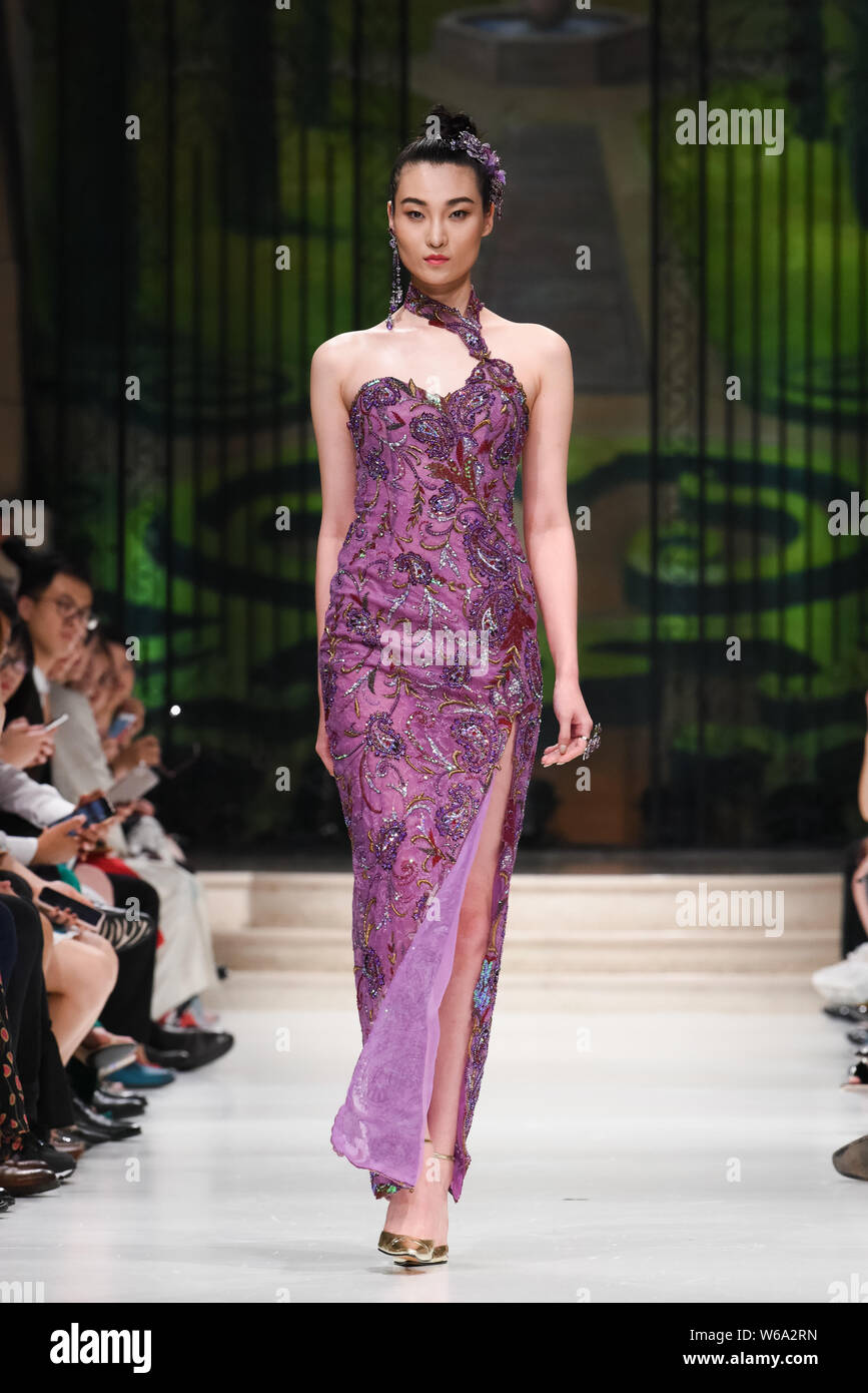 A model displays a new creation at the fashion show of Yumi Katsura ...