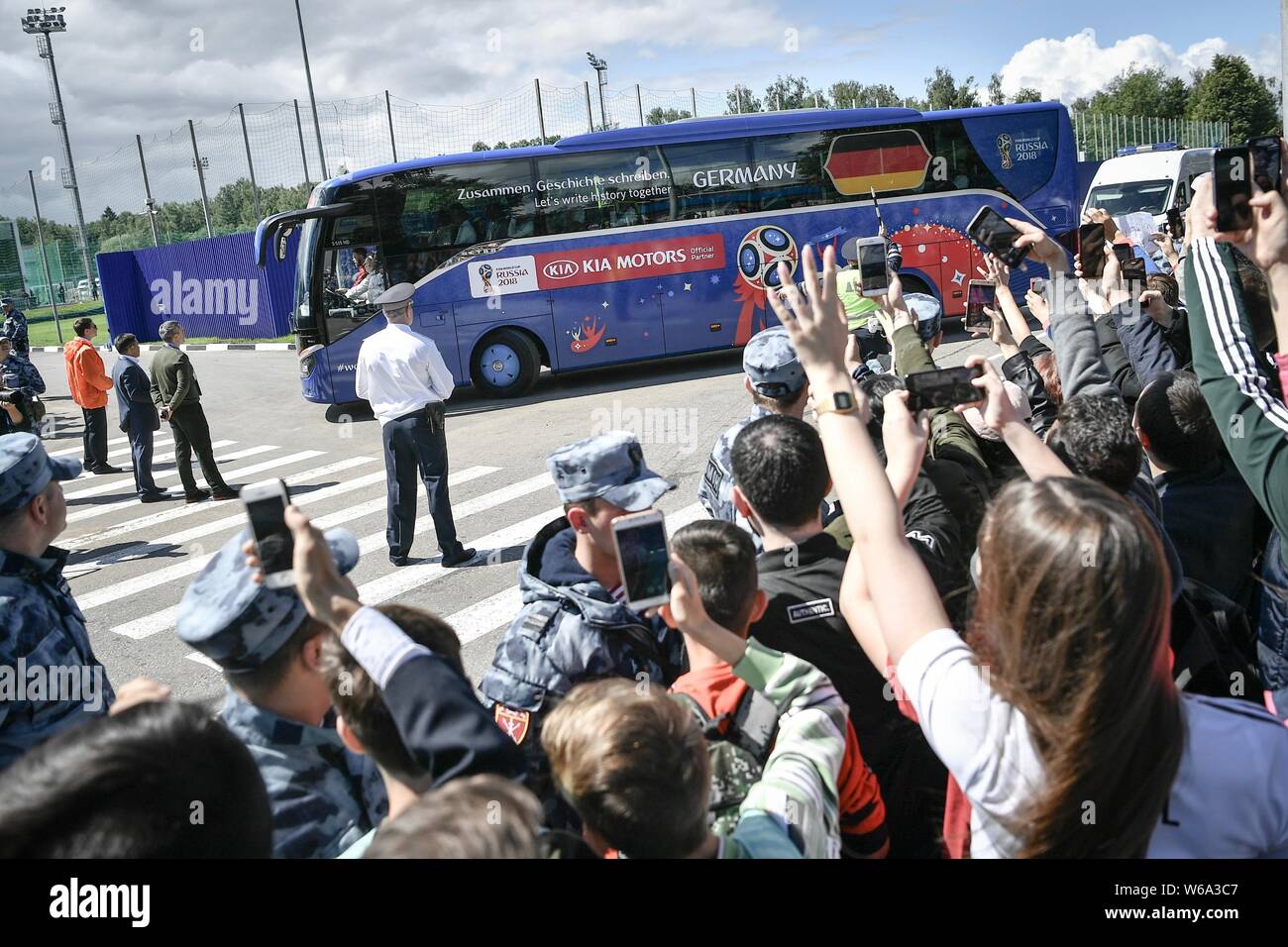 Crowds of football fans take photos of the bus carrying German players ...