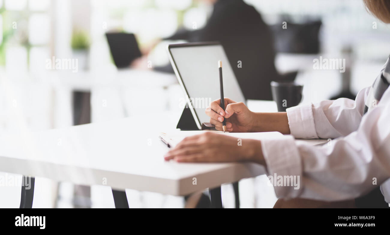 Smart female startup member writing her perspectives about new ...