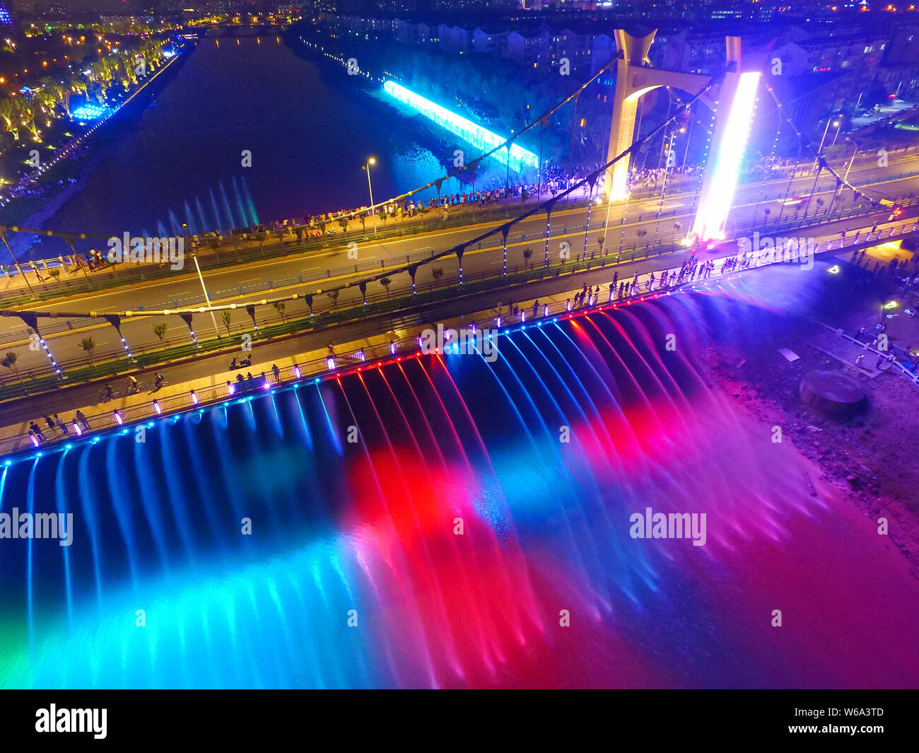 Aerial view of the Xiaolongwan bridge illuminated by colorful lights in ...