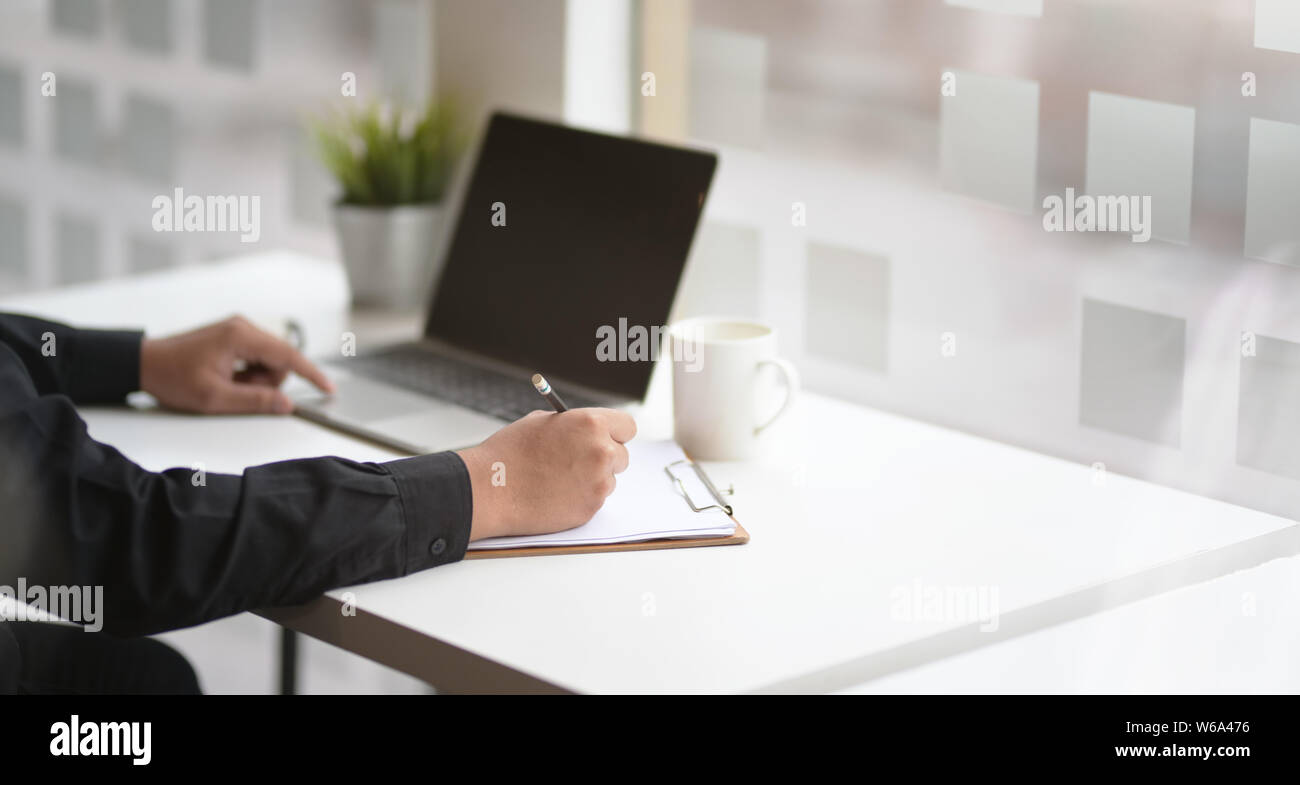 Motivated business man focusing on his project while using laptop Stock ...