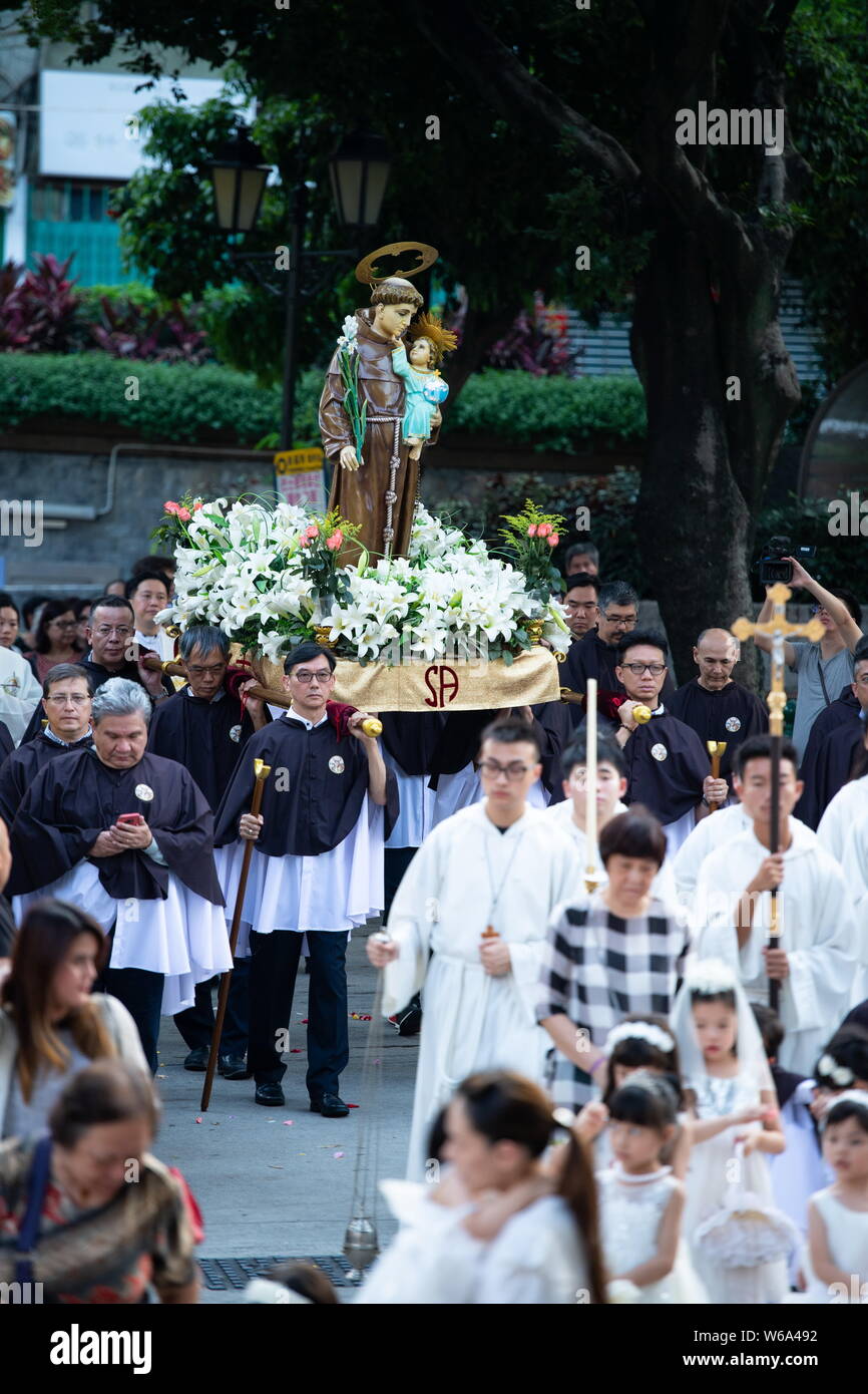 Members of a confraternity or brotherhood carry the statue of St ...