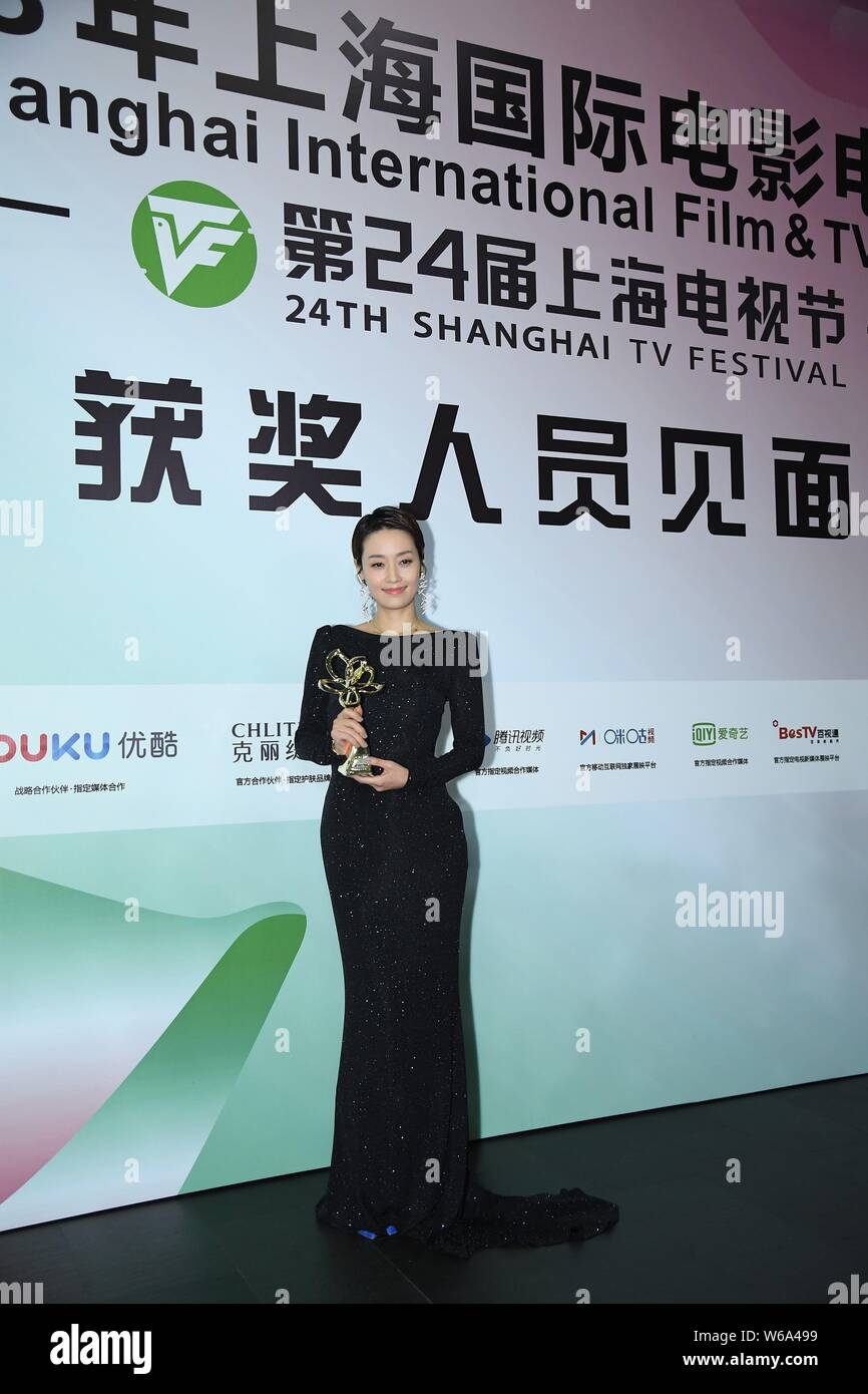 Chinese actress Ma Yili poses with her trophy for the Best Actress ...