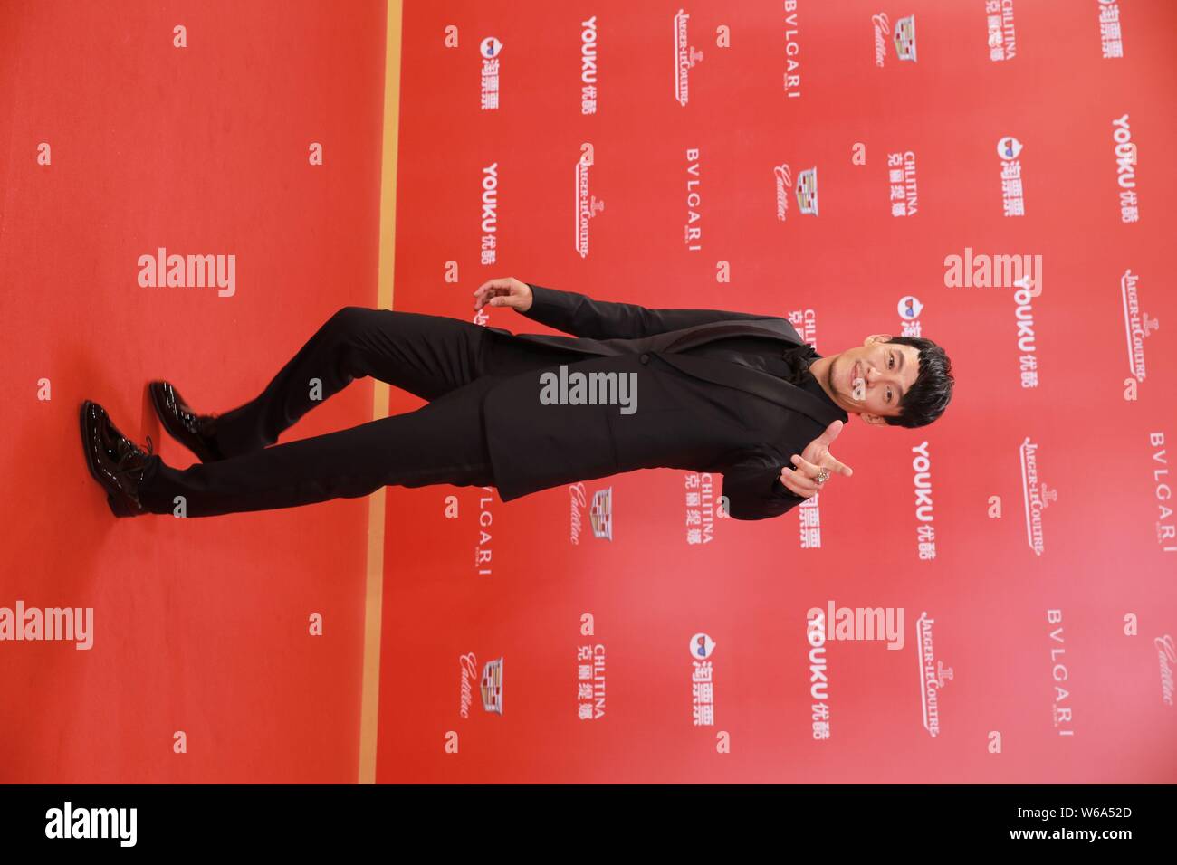 Taiwanese actor Zhang Zhen poses as he arrives on the red carpet for ...