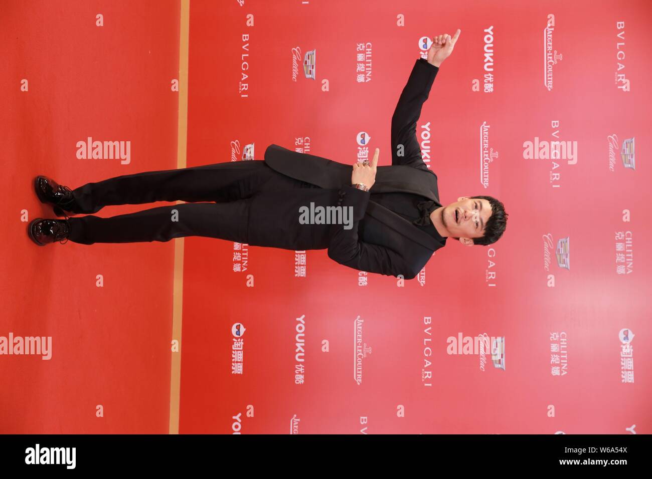 Taiwanese actor Zhang Zhen poses as he arrives on the red carpet for ...