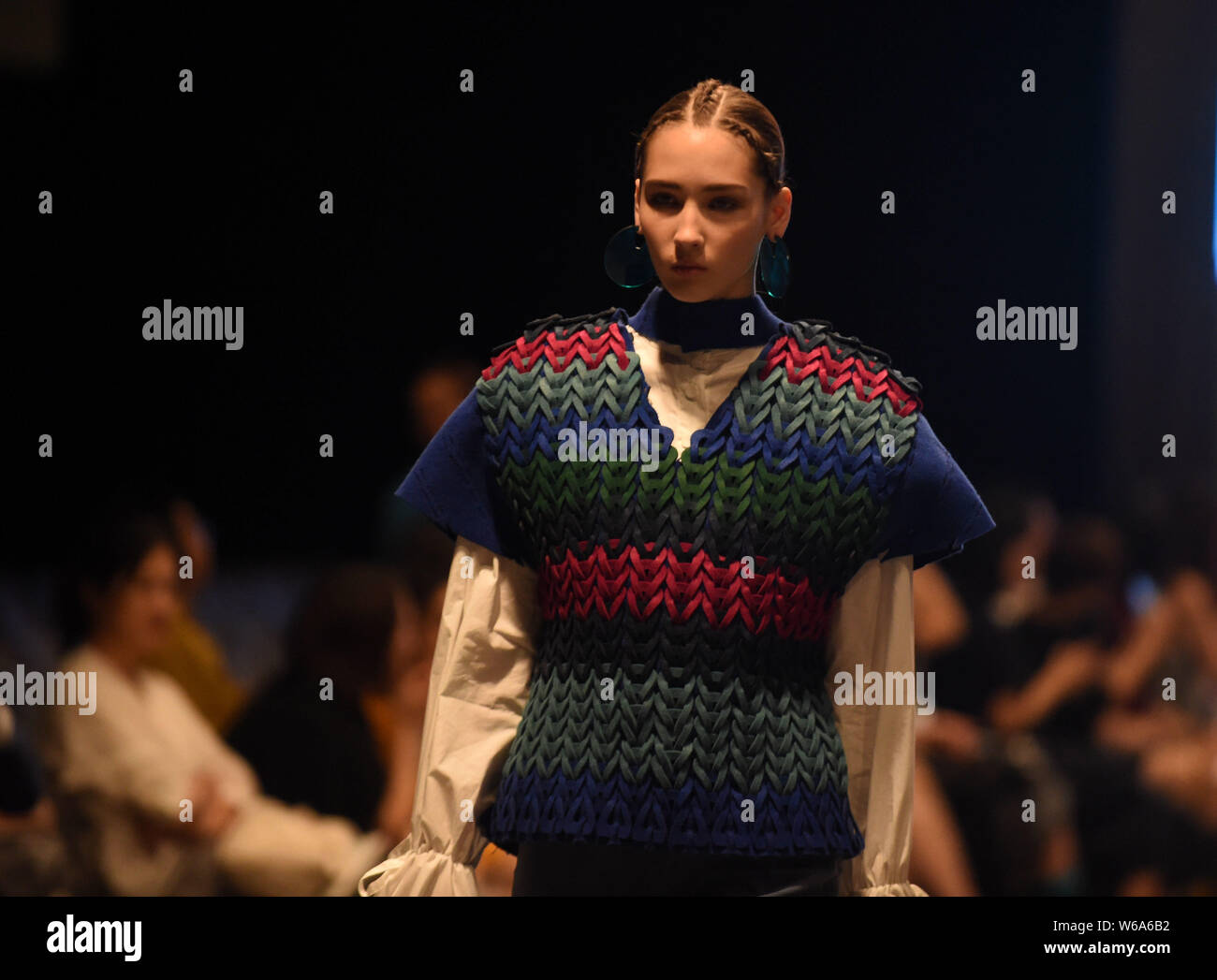 A model displays a new creation by a graduate during a fashion show for ...