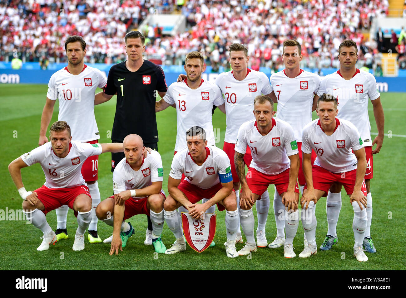 Members of the starting line-up of Poland pose for photos before their ...
