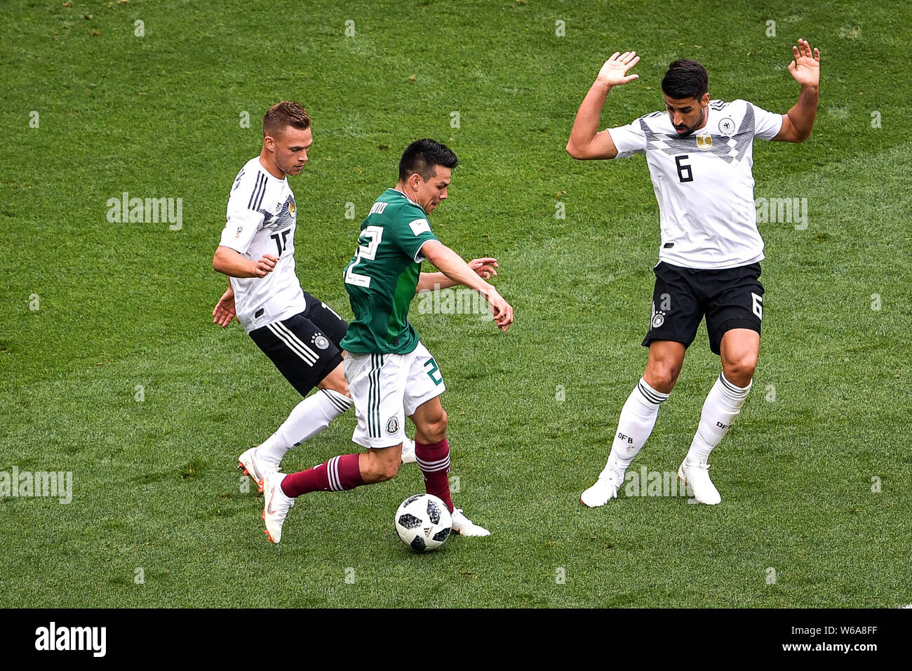 Hirving Lozano of Mexico, center, dribbles against players of Germany ...