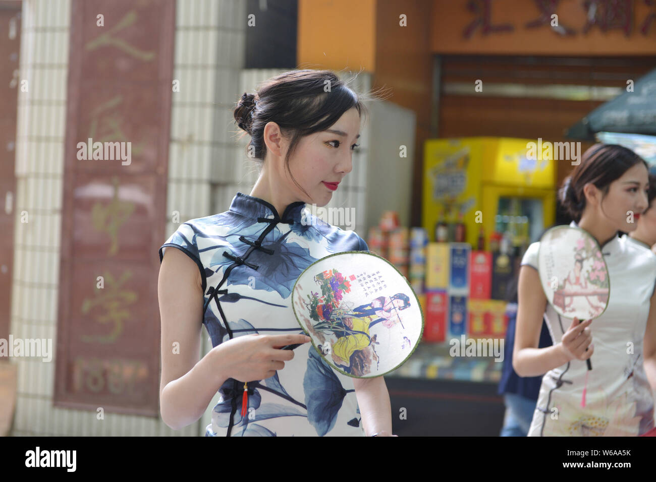 Four Chinese women dressed in cheongsam, also known as qipao in Chinese ...