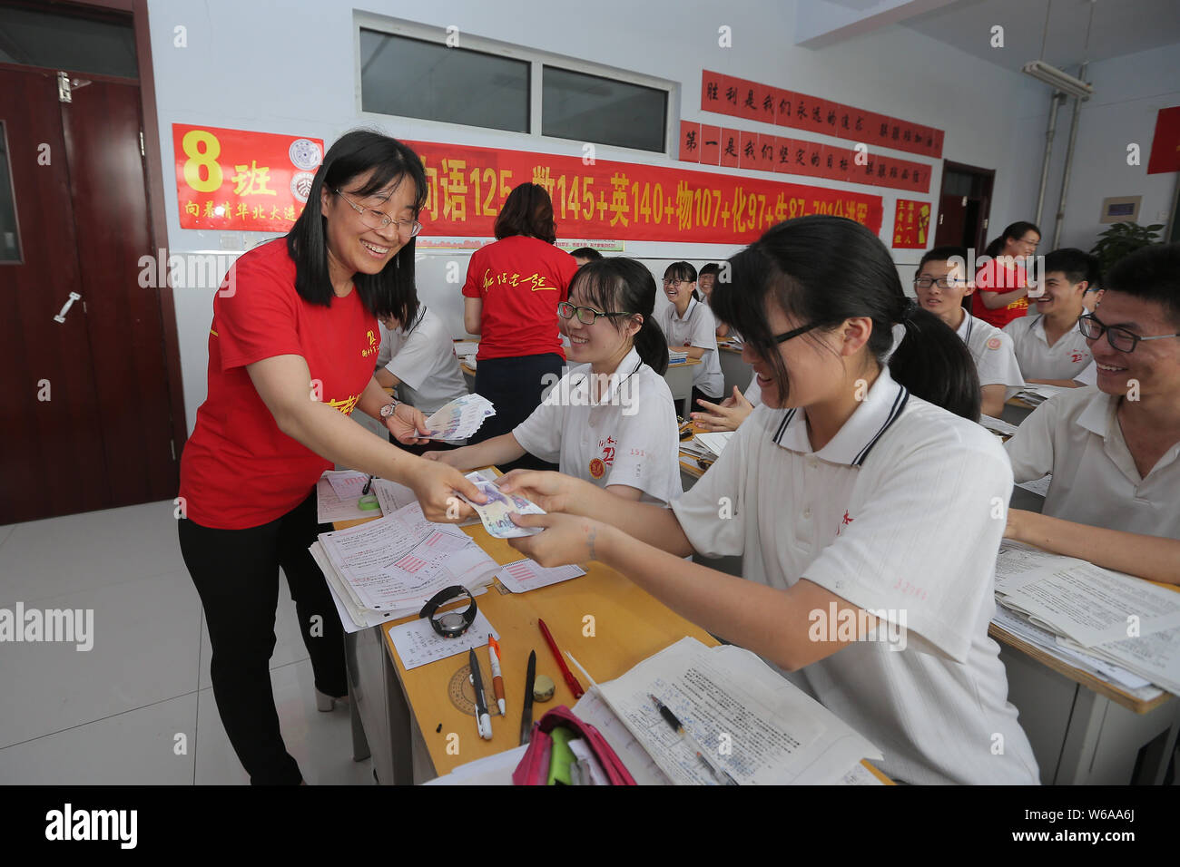 Chinese teachers distribute 5-yuan banknotes as lucky money to their ...