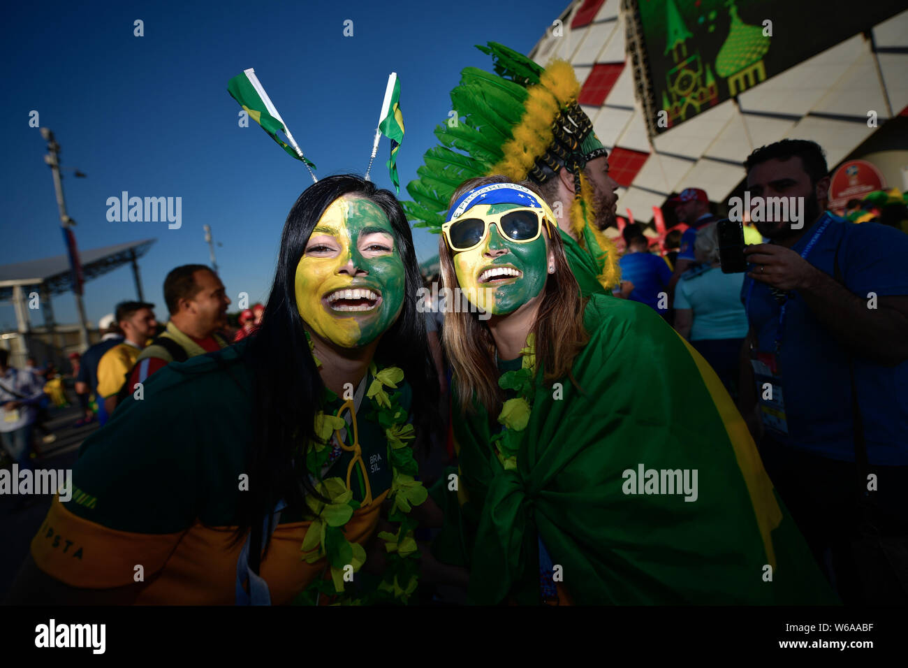 Fans show Brazilian national flags painted on their faces outside the ...