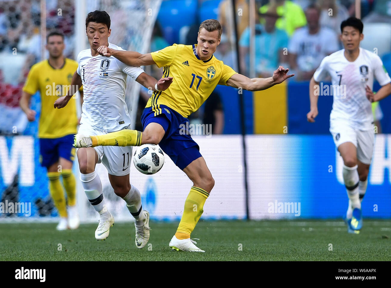 Hwang Hee-chan of South Korea, left, challenges Viktor Claesson of ...