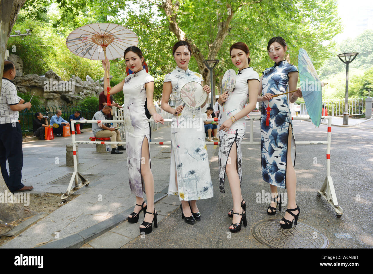Four Chinese women dressed in cheongsam, also known as qipao in Chinese ...