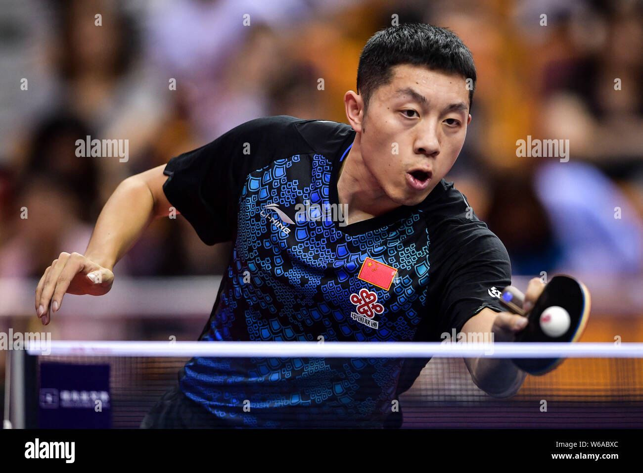 Xu Xin of China returns a shot to Lim Jong-hoon of South Korea in their ...