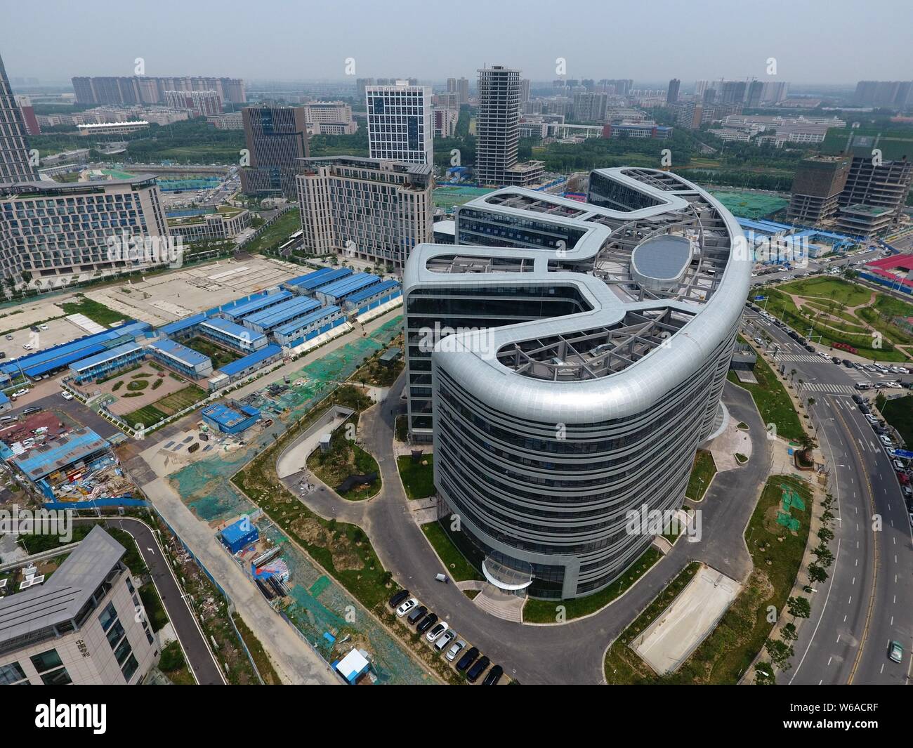 In this aerial view, an office building features the shape of rake or ...