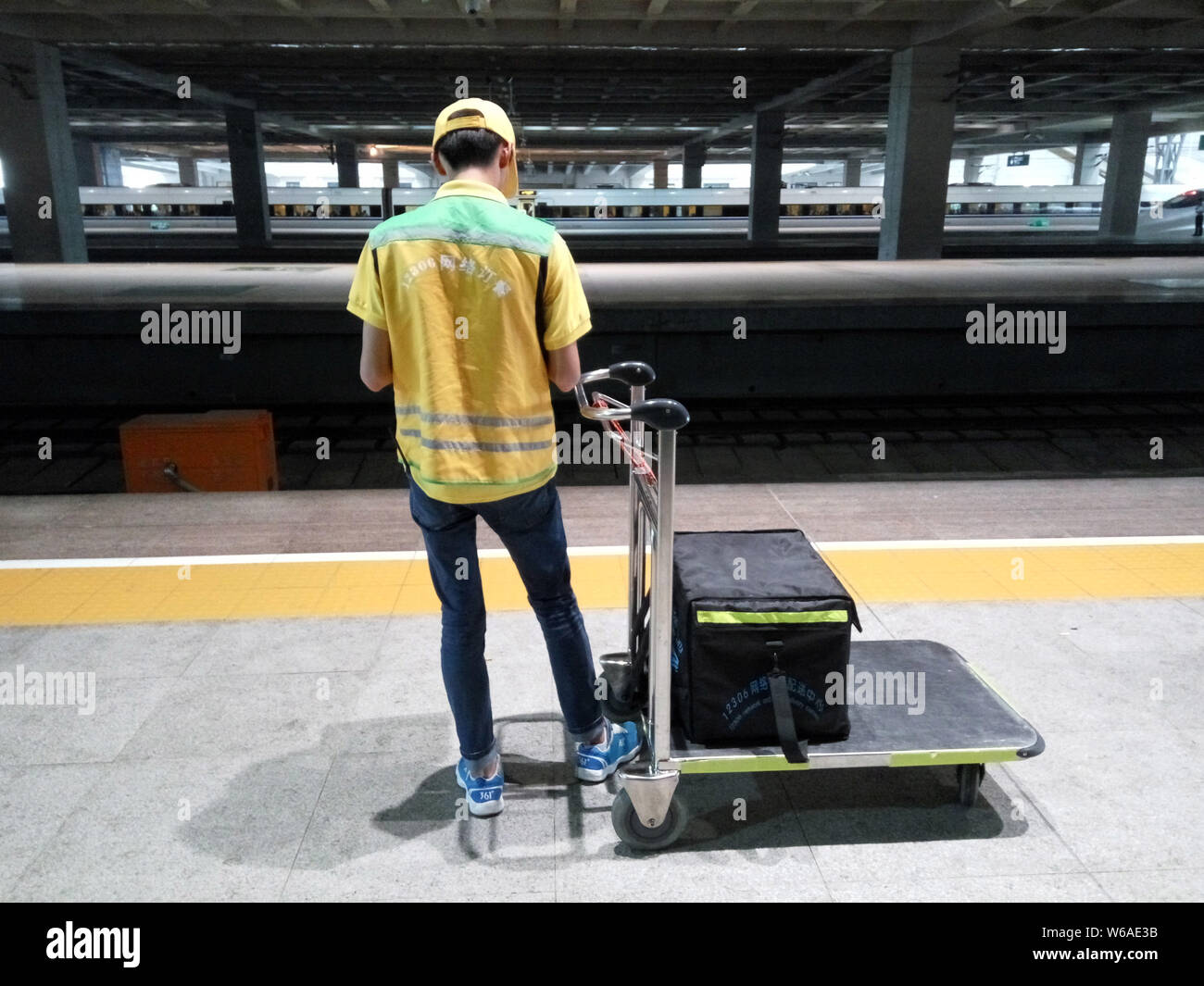 --FILE--A food delivery courier waits for a bullet train to deliver ...