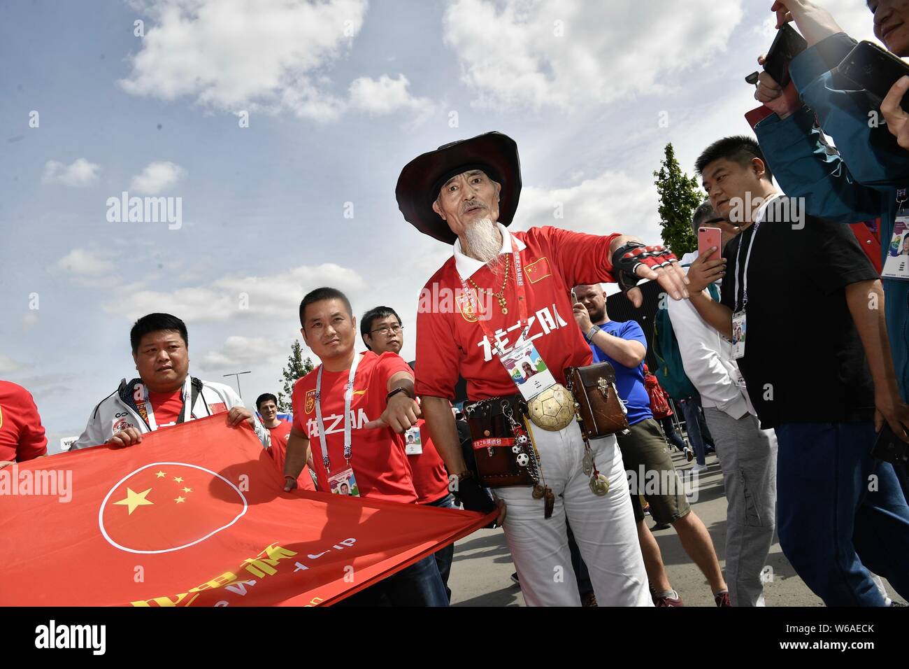 Members of Chinese Football Fans Association of Team Dragon wave flag ...
