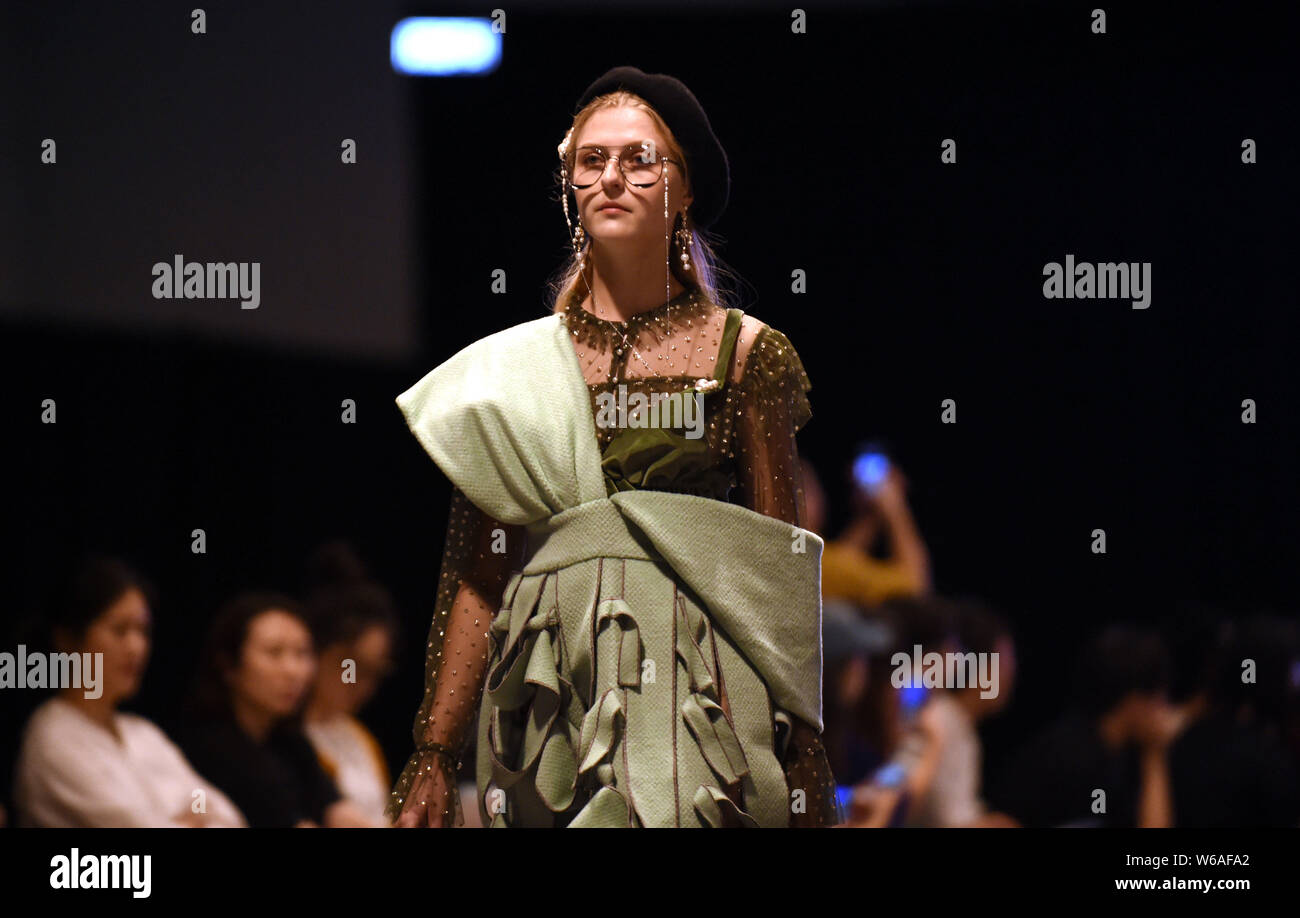 A model displays a new creation by a graduate during a fashion show for ...