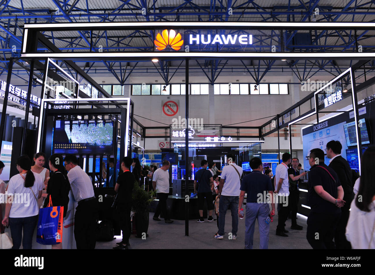 --FILE--People visit the stand of Huawei during an exhibition in ...