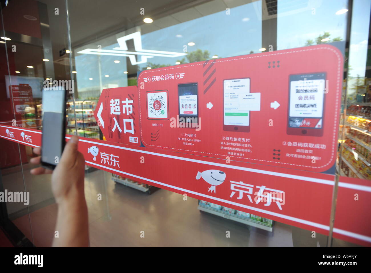 A customer uses his smartphone to scan a QR code at an unmanned ...