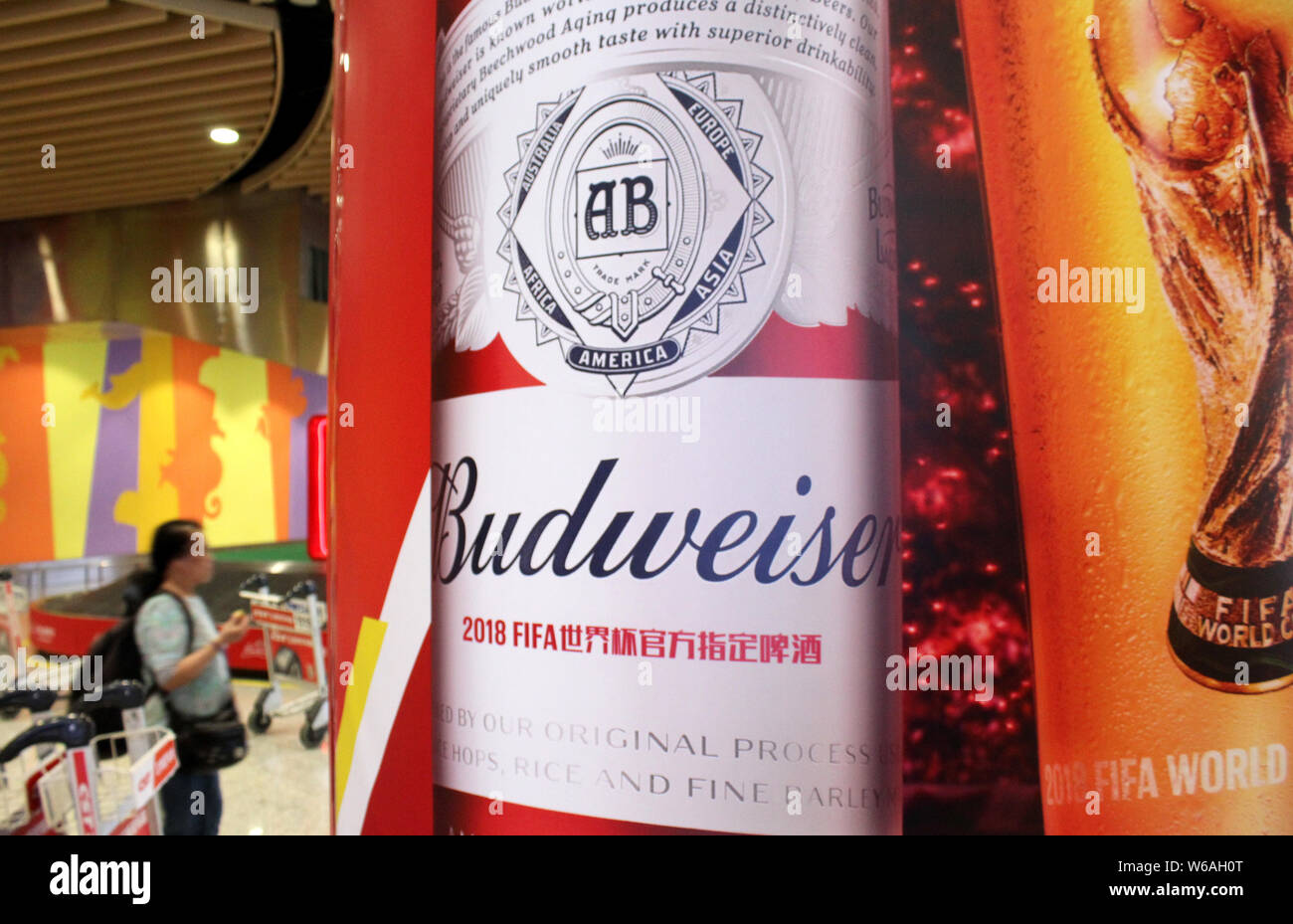 --FILE--A pedestrian walks past an advertisement for Budweiser beer of Anheuser-Busch InBev ...