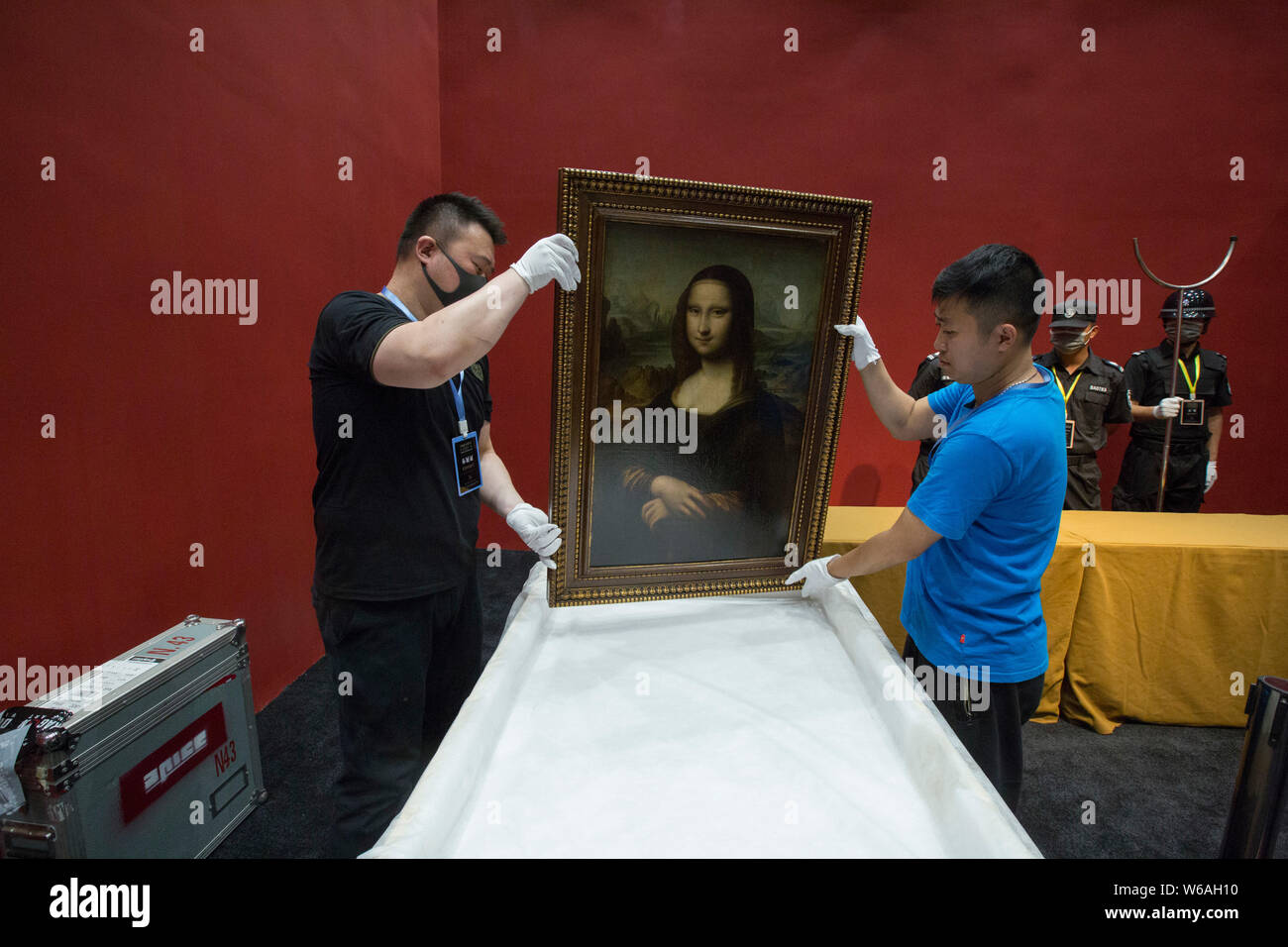Chinese security guards show an artwork by an apprentice of Italian ...