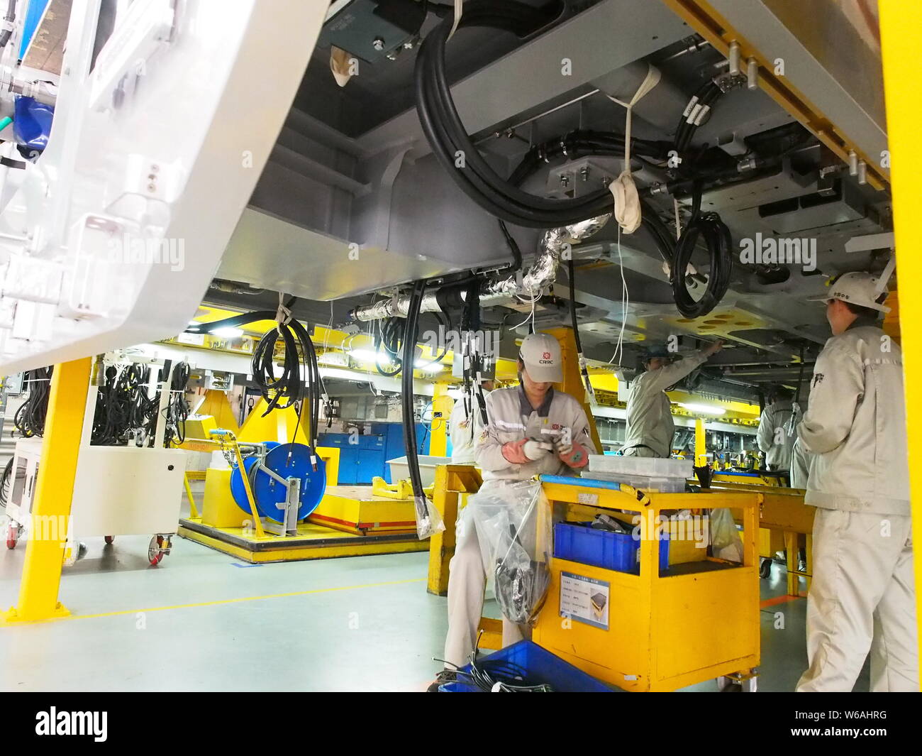 Chinese workers manufacture a "Fuxing" high-speed bullet train at the ...