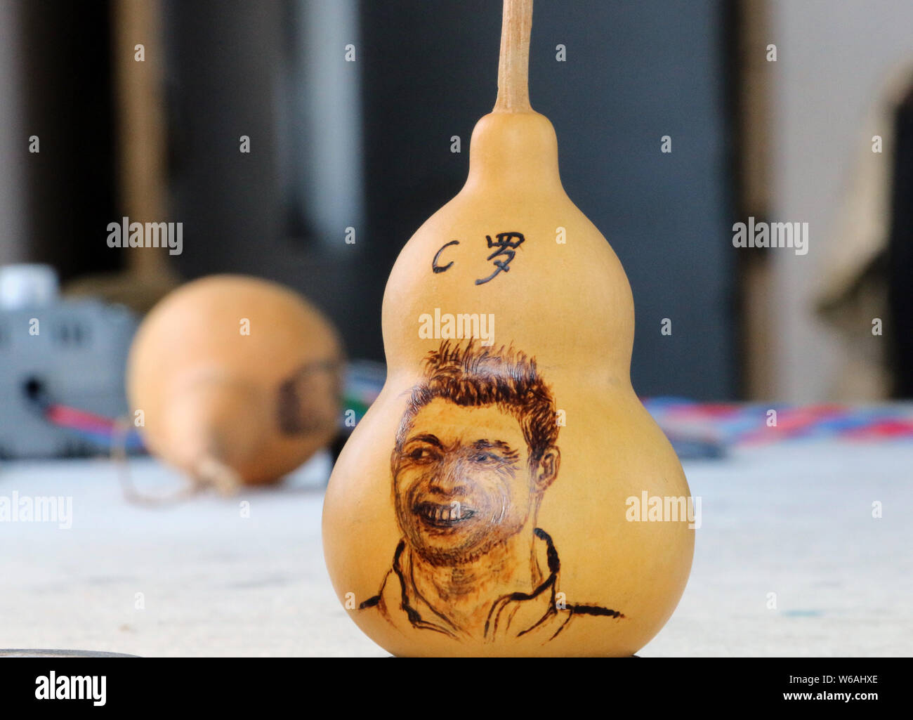 A calabash decorated with a picture of Portuguese football player ...