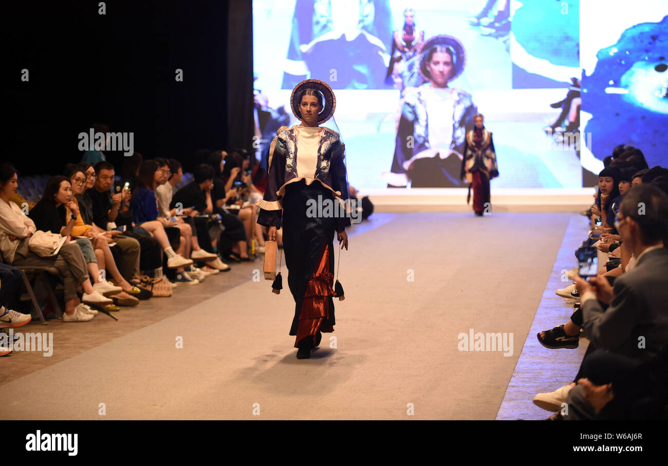 A model displays a new creation by a graduate during a fashion show for ...