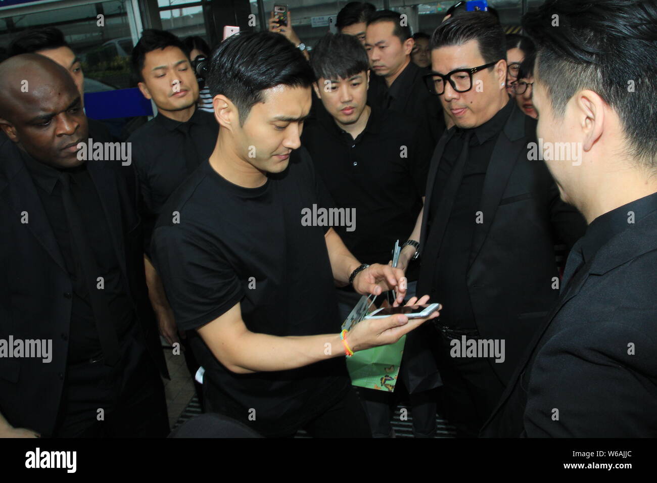 South Korean singer and actor Choi Si-won, center, of South Korean boy ...