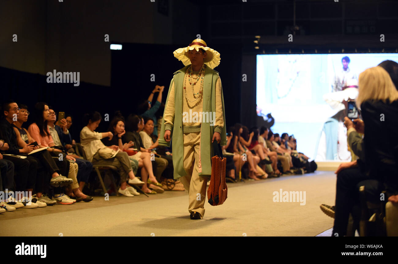 A model displays a new creation by a graduate during a fashion show for ...