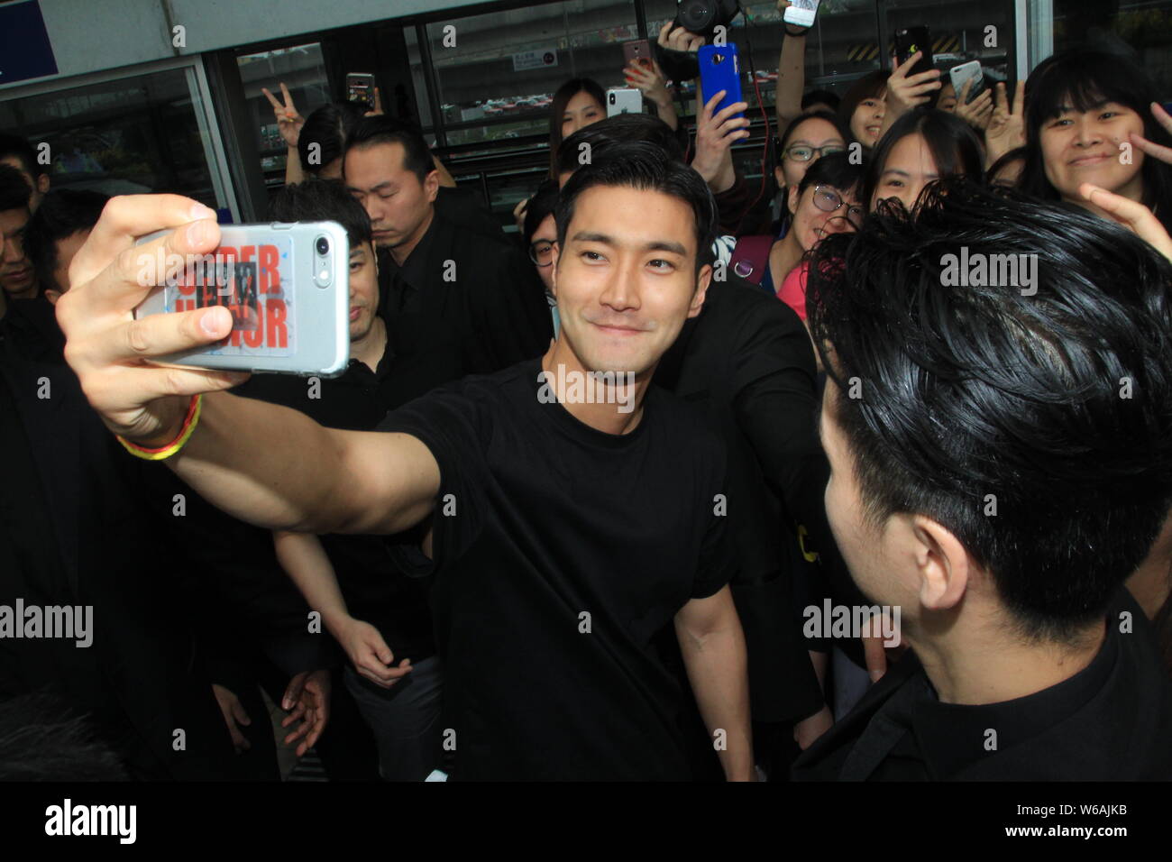 South Korean singer and actor Choi Si-won, center, of South Korean boy ...
