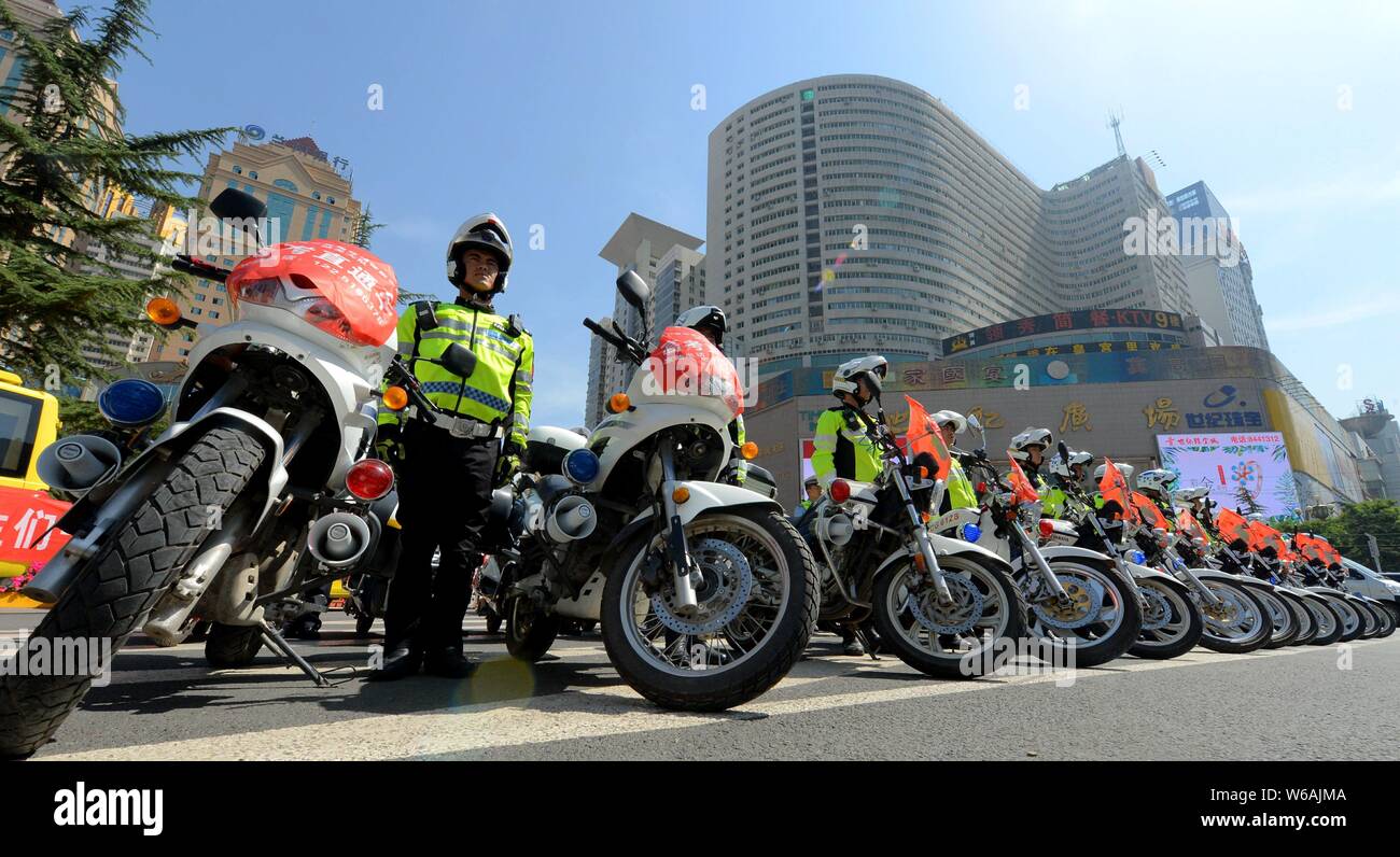 Chinese auxiliary traffic police officers pose with motorcycles during ...
