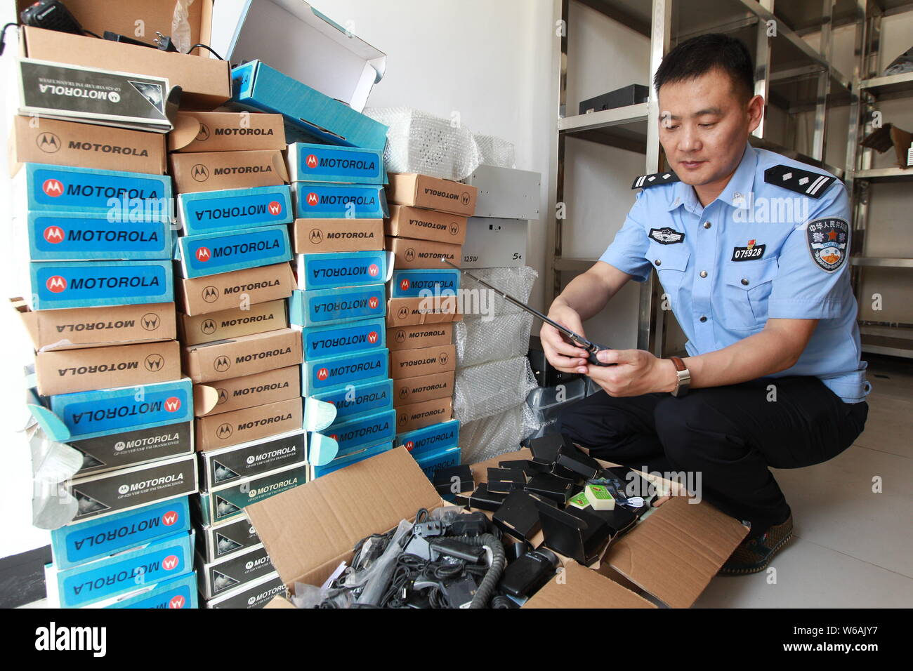 A Chinese police officer shows cheating device for the upcoming annual ...