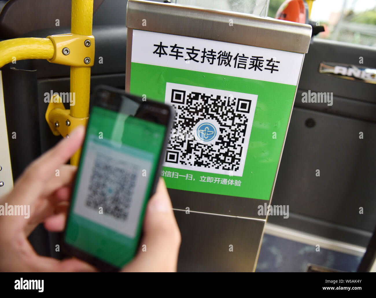 A local resident uses his smartphone to have the QR code scanned ...